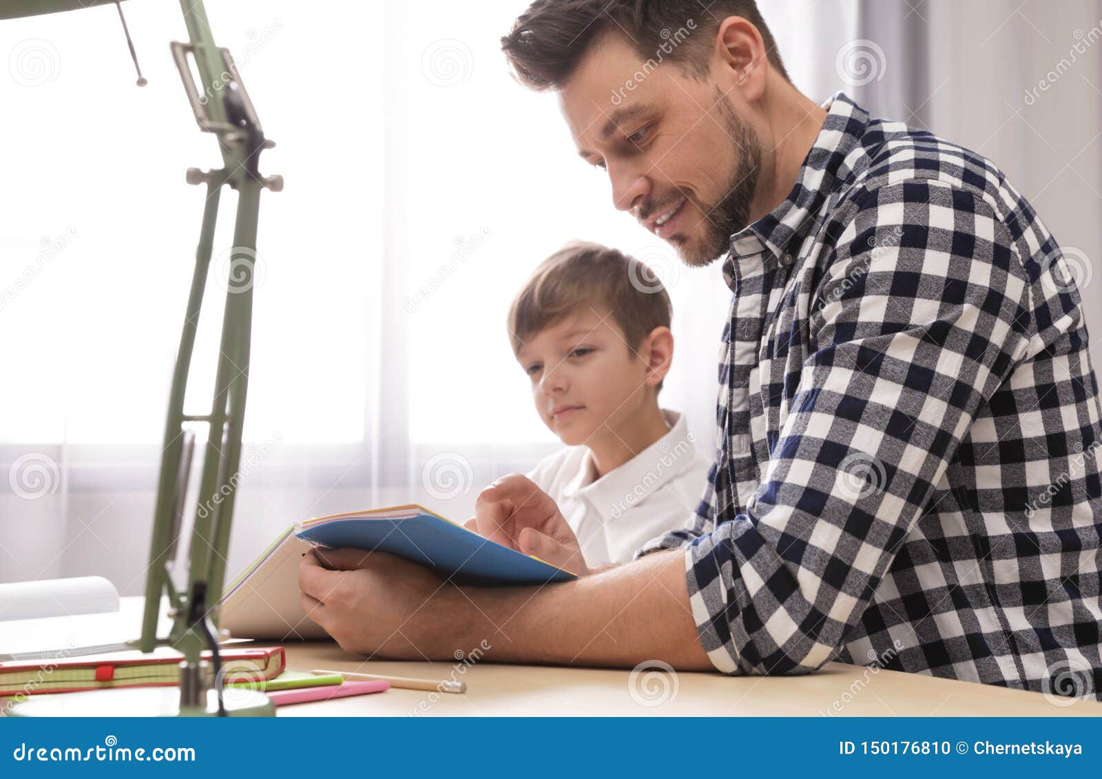 Dad Helping His Son with School Assignment Stock Photo - Image of love ...