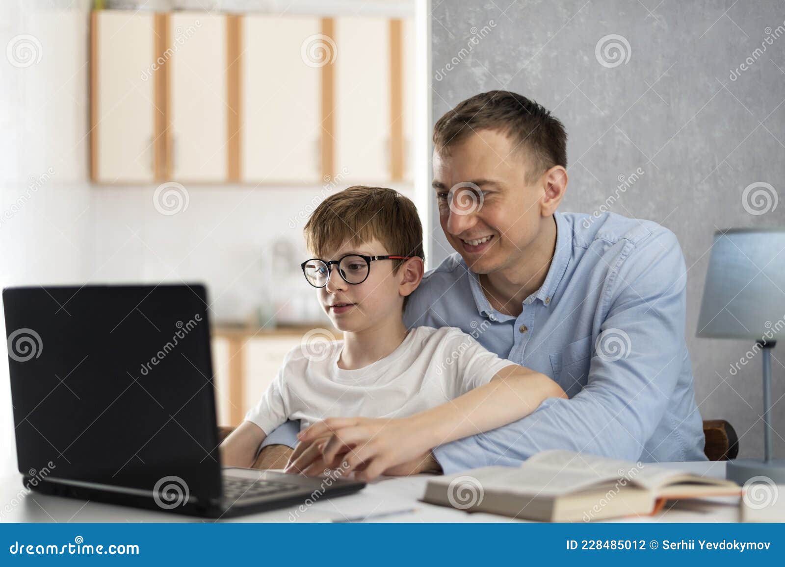 Dad Helps His Son Do Homework. Boy is Doing Homework with His Father ...