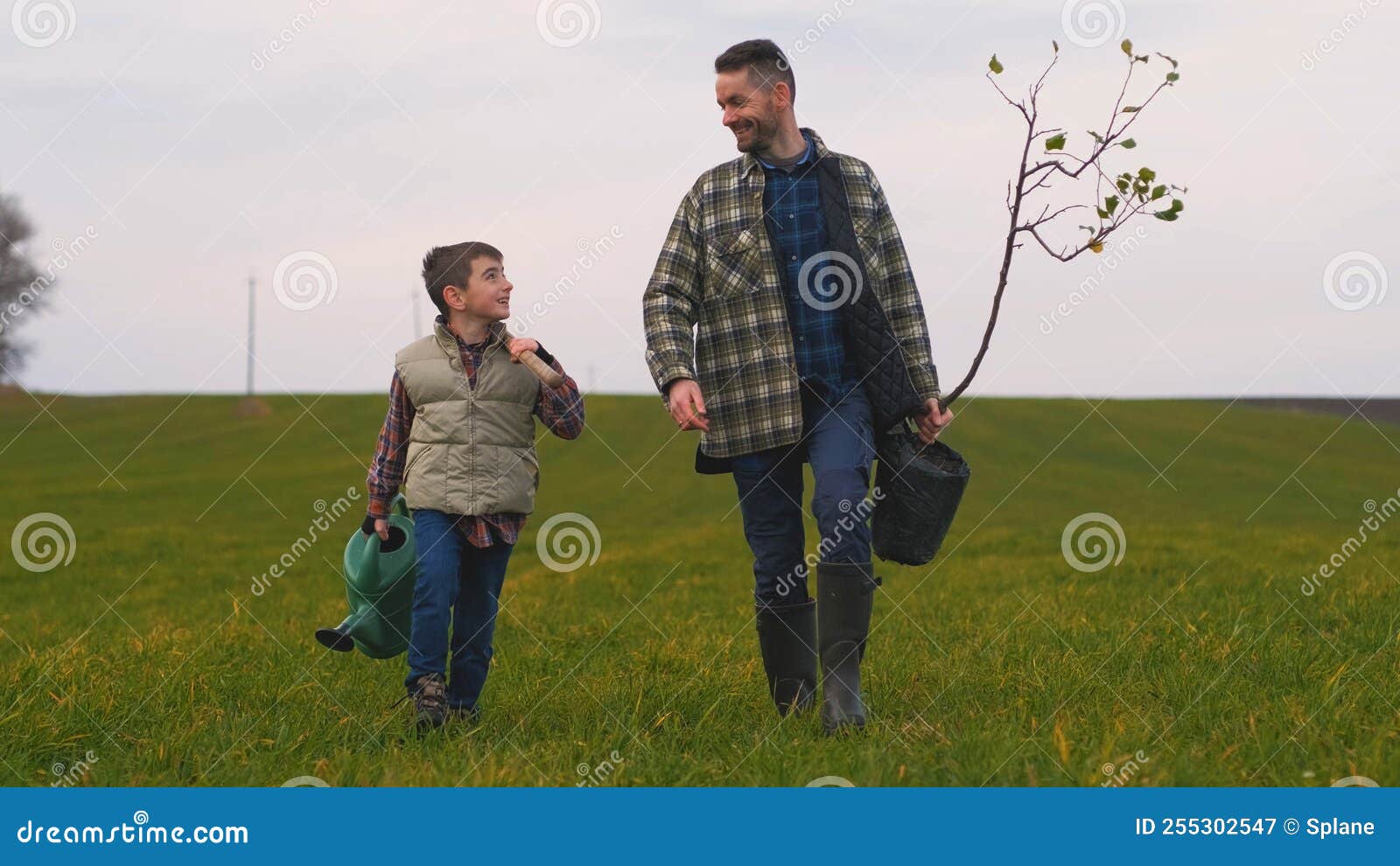 The Dad with His Little Son are Going To Plant a Tree. Stock Image ...