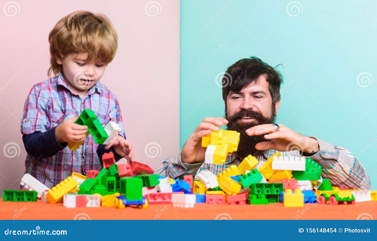 Dad and Kid Build of Plastic Blocks. Father and Son Create Colorful ...