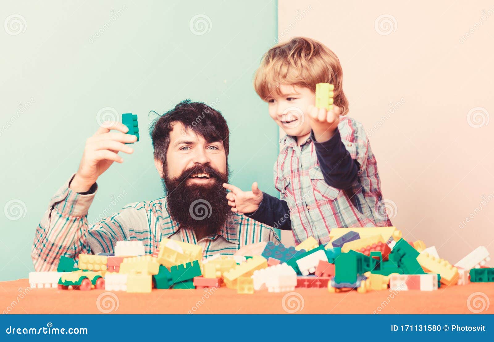 Dad and Kid Build of Plastic Blocks. Father and Son Create Colorful ...