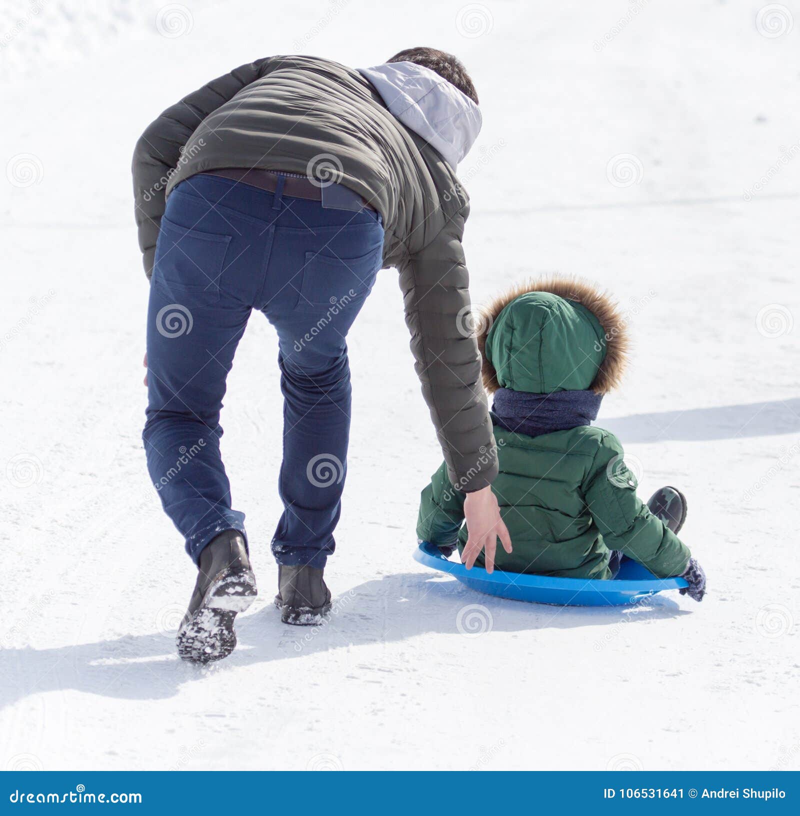 Dad Rolls the Child on a Sled Stock Image - Image of young, father ...
