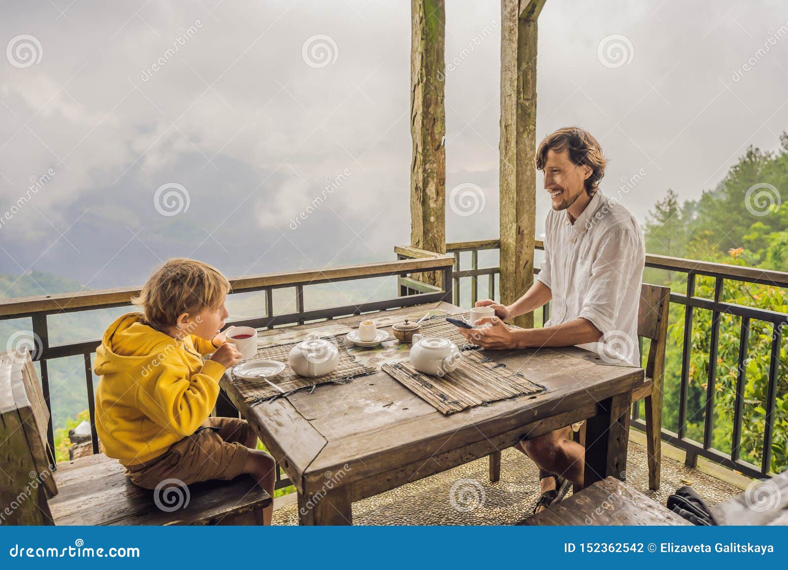 Dad and Son Drinking Tea in a Cafe in the Mountains Stock Photo - Image ...