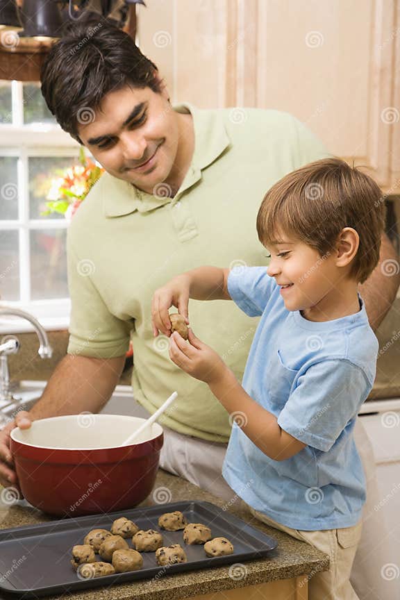 Dad and Son Making Cookies. Stock Photo - Image of father, male: 4246492