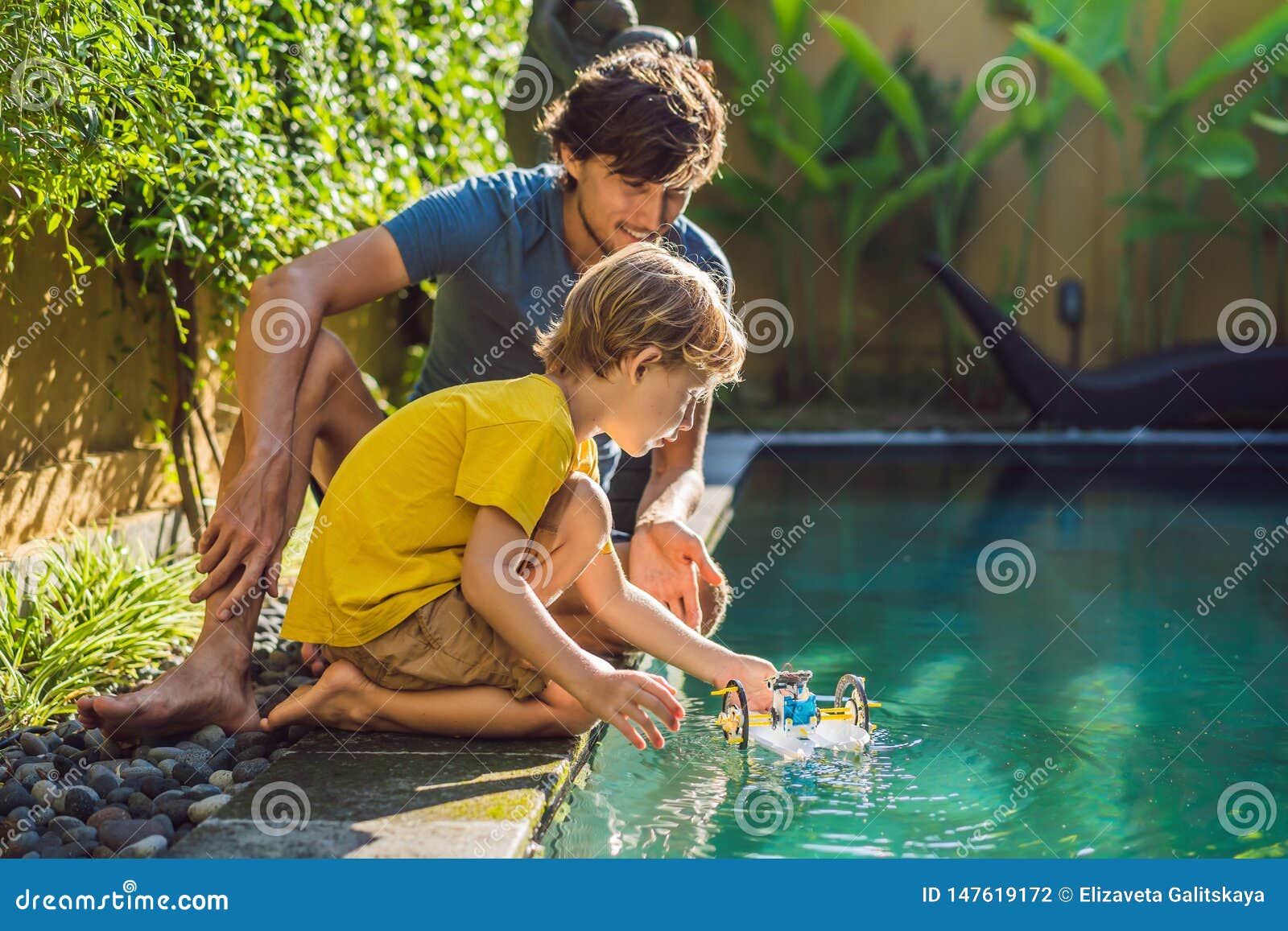 Dad and Son Playing with a Boat in the Pool Stock Photo - Image of ...