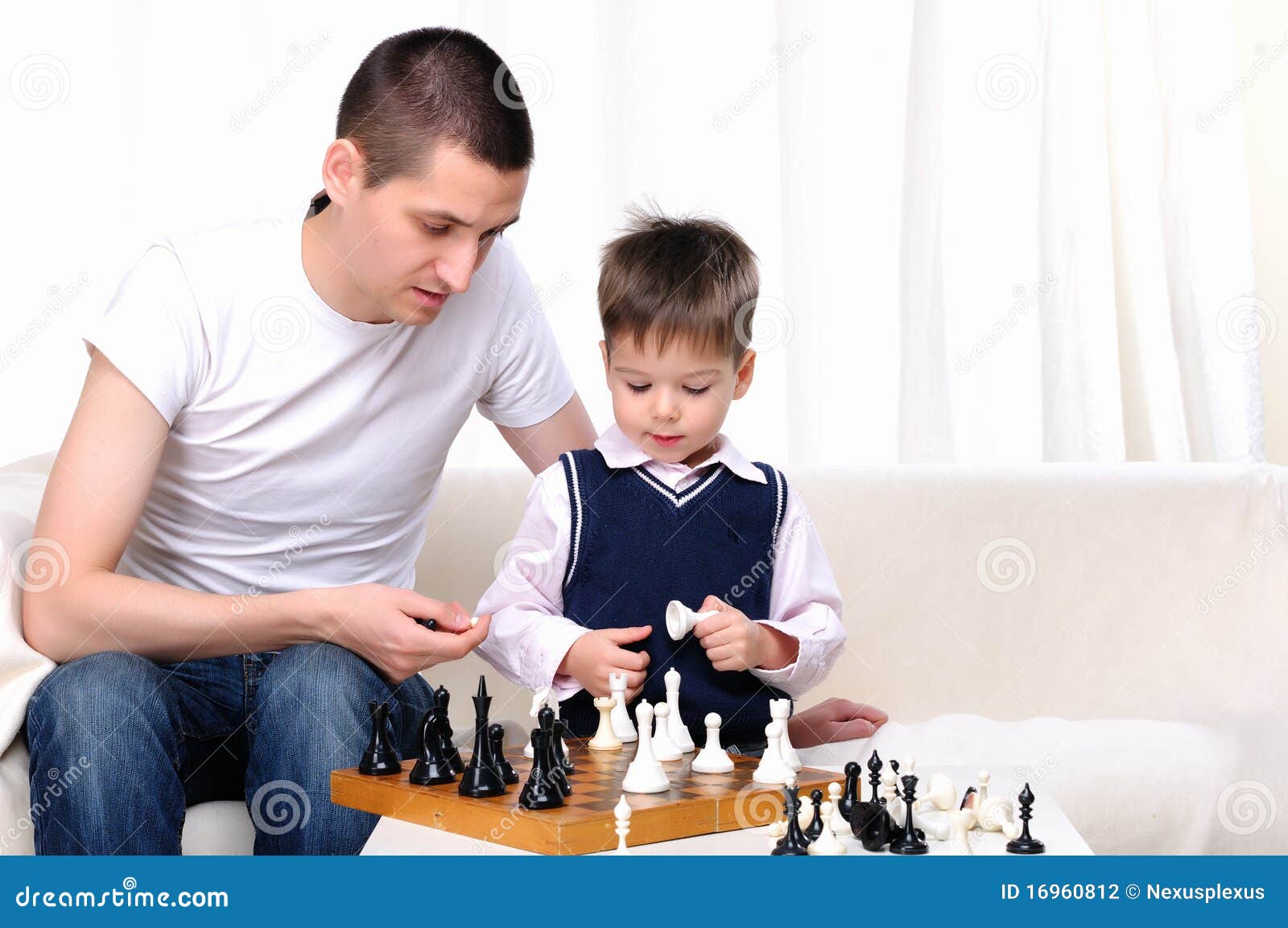 Dad and son playing chess stock photo. Image of group - 16960812