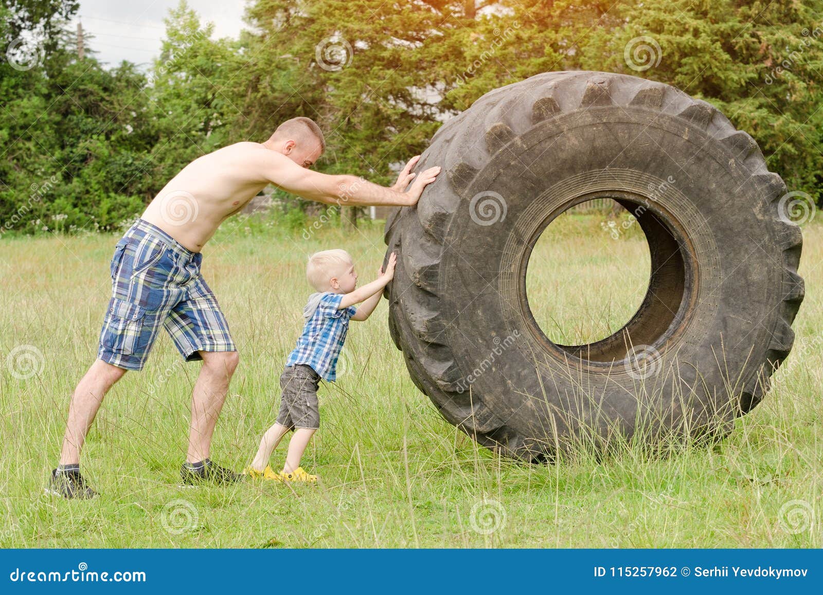 Dad and Son Push a Big Tire. Street Workout Stock Photo - Image of ...