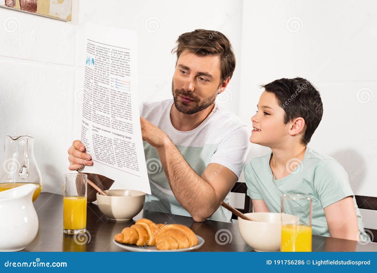 Dad and Son Reading Newspaper during Breakfast Stock Photo - Image of ...