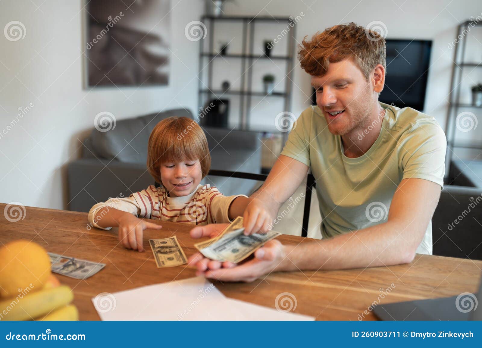 Dad and Son Sitting Together at the Table and Calculating Money Stock ...