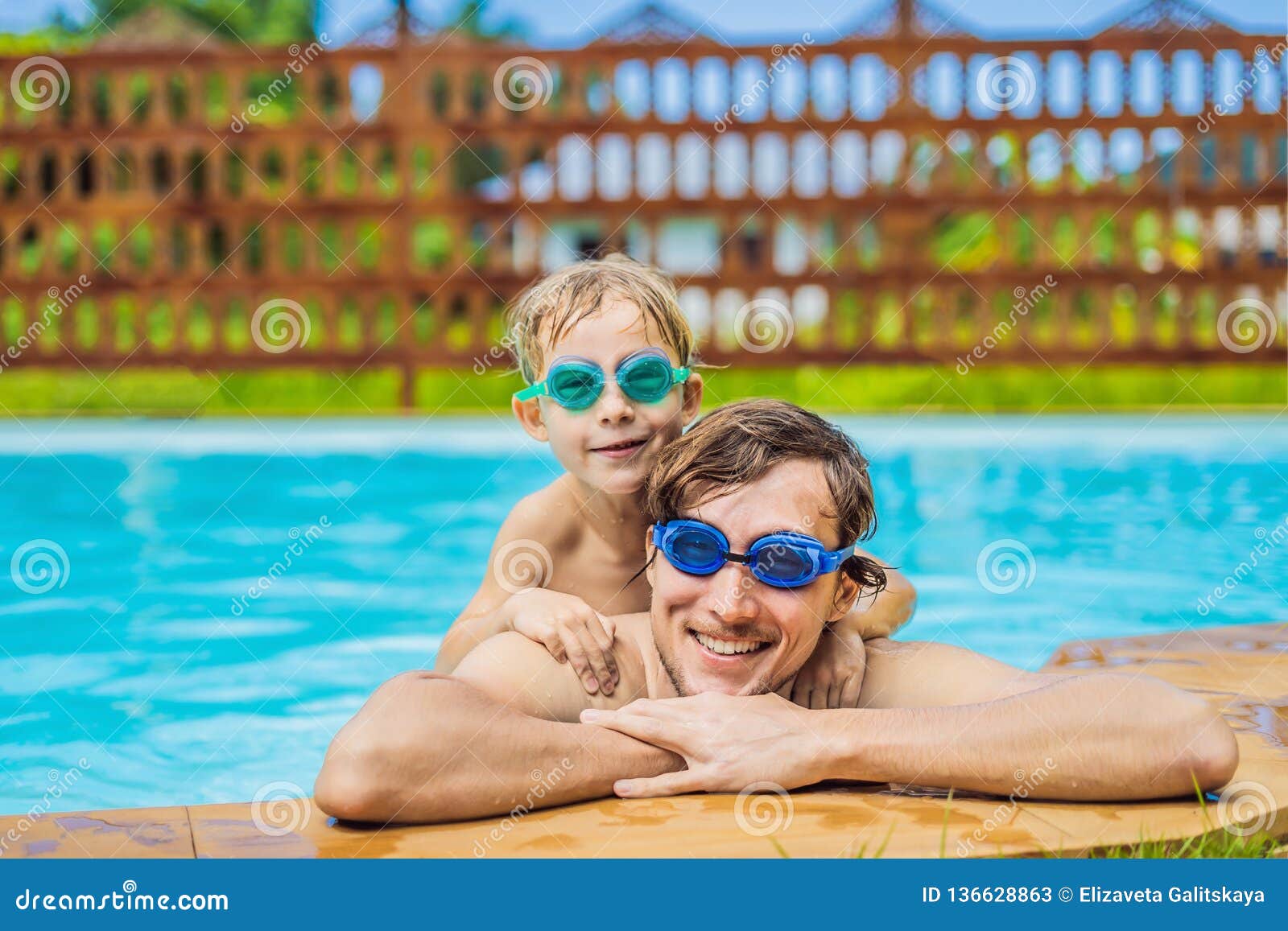 Dad and Son in Swimming Goggles Have Fun in the Pool Stock Image ...