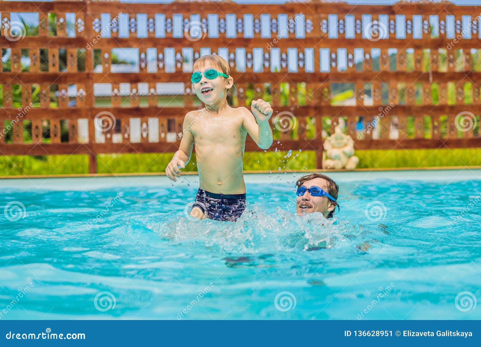 Dad and Son in Swimming Goggles Have Fun in the Pool Stock Image ...