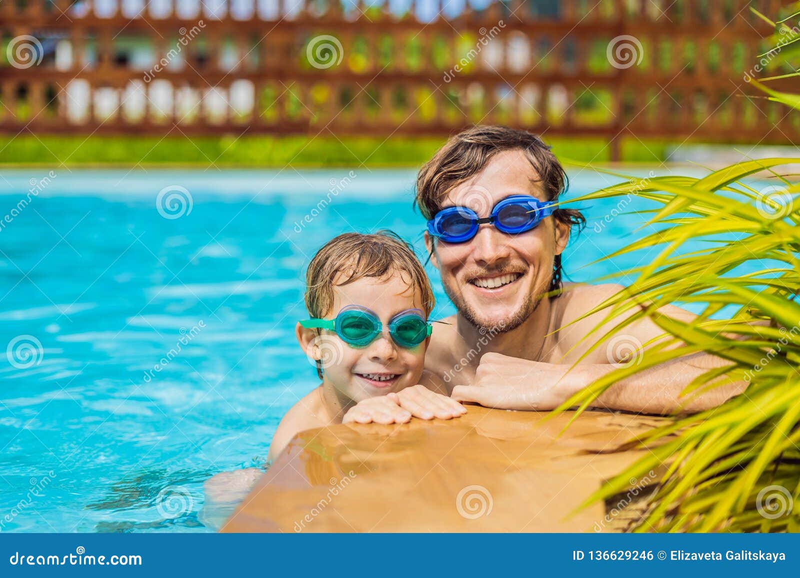 Dad and Son in Swimming Goggles Have Fun in the Pool Stock Photo ...