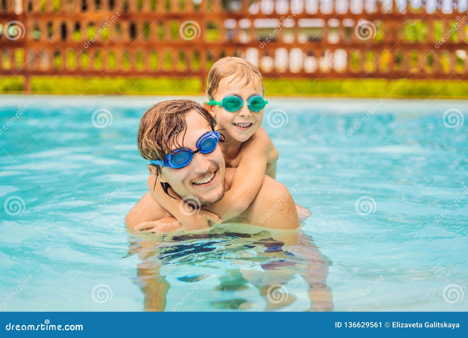 Dad and Son in Swimming Goggles Have Fun in the Pool Stock Image ...