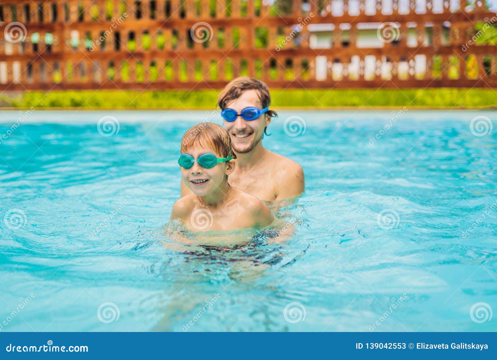 Dad and Son in Swimming Goggles Have Fun in the Pool Stock Image ...