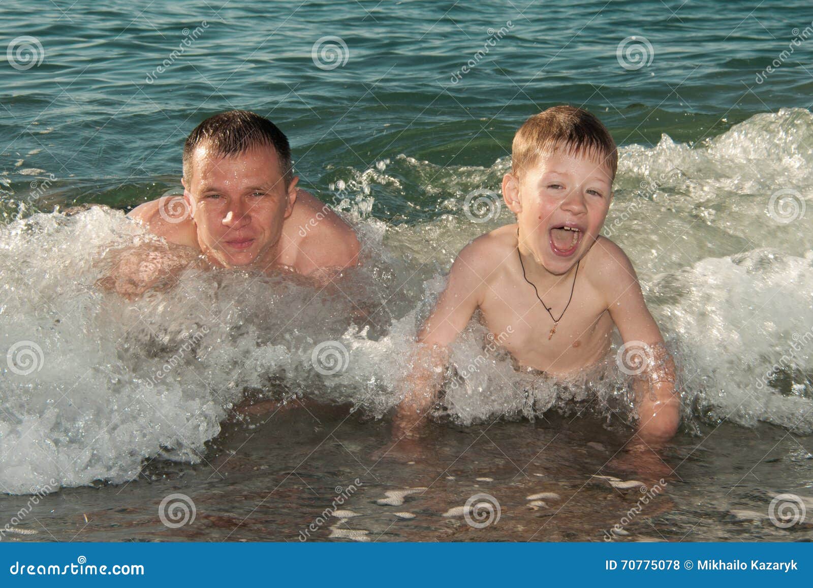 Dad and son in the waves stock photo. Image of wave, recreational ...