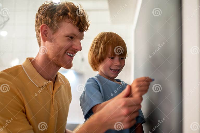 Dad Teaching a Little Boy To Write on the Blackboard Stock Image ...