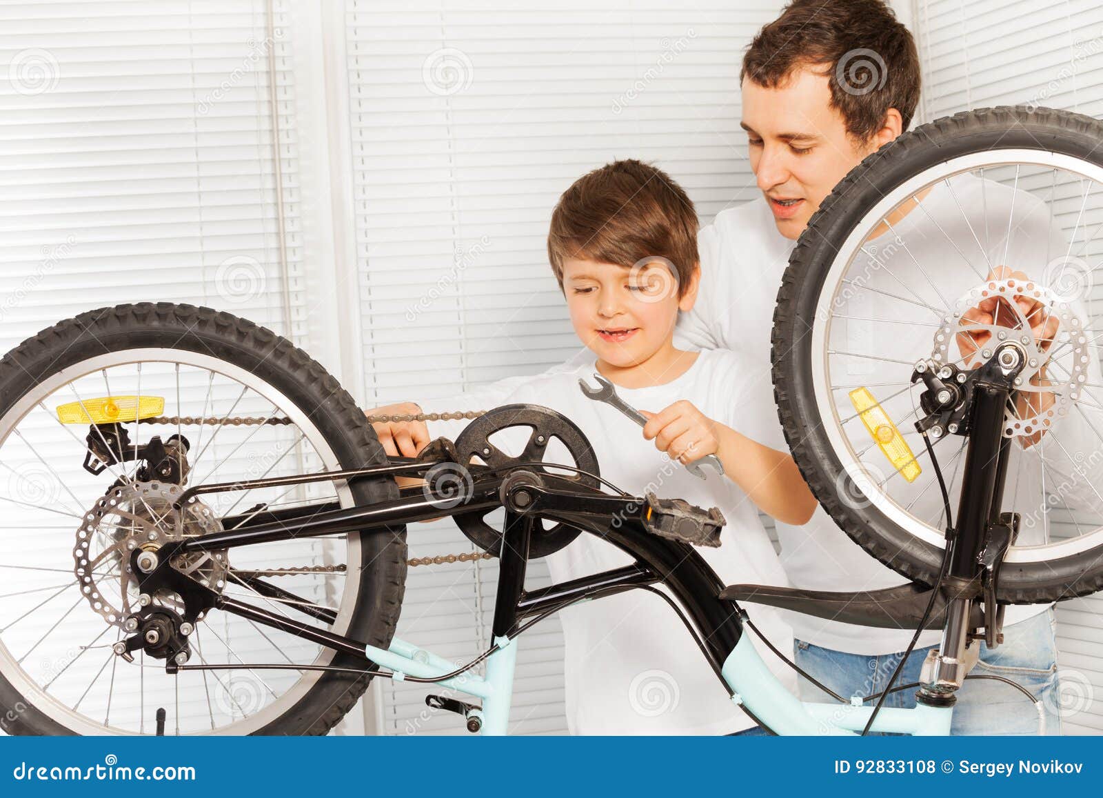 Dad Teaching Son Repairing Bicycle Using Spanner Stock Photo - Image of ...