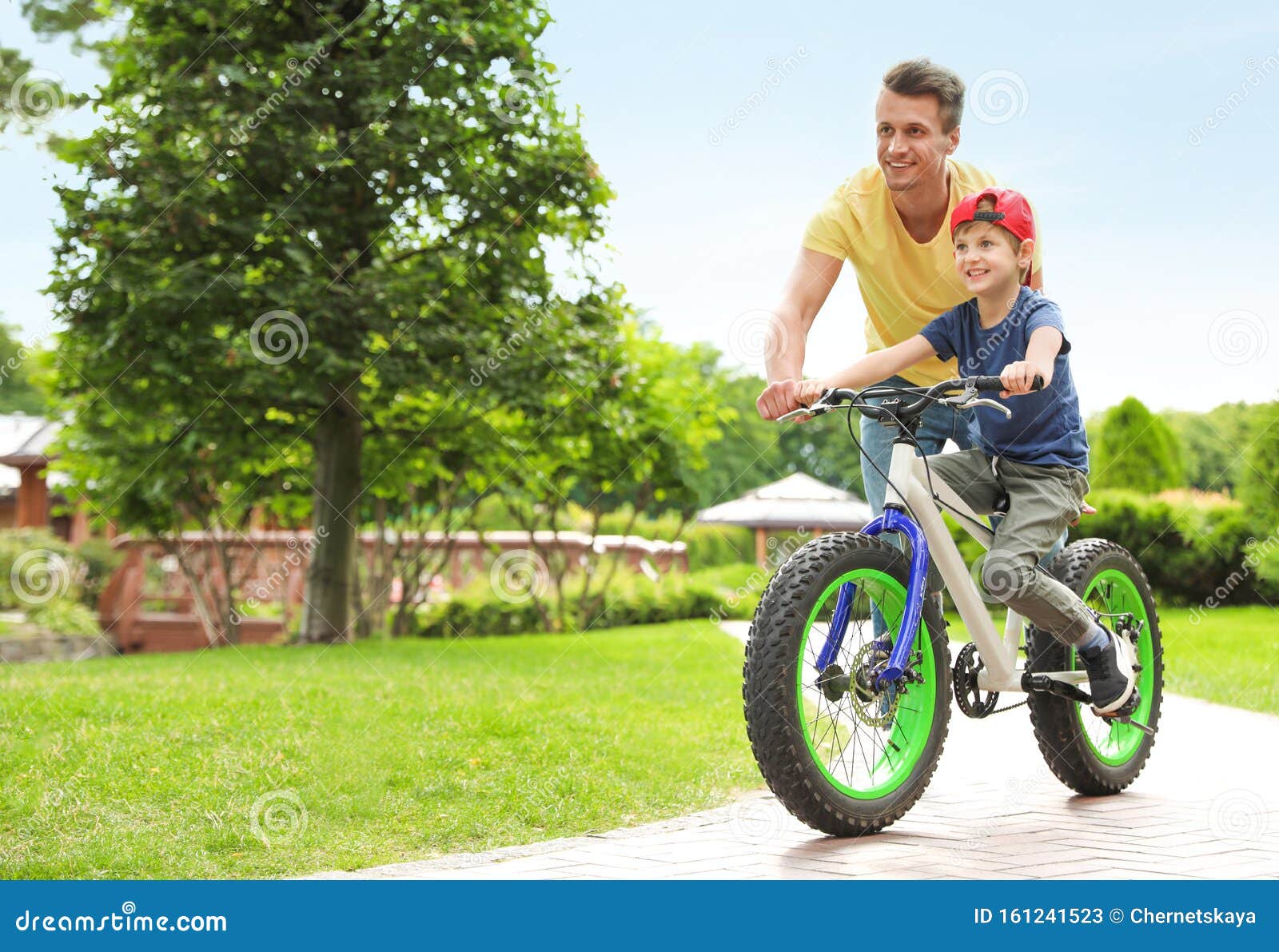 Dad Teaching Son To Ride Bicycle Stock Image - Image of father, ride ...