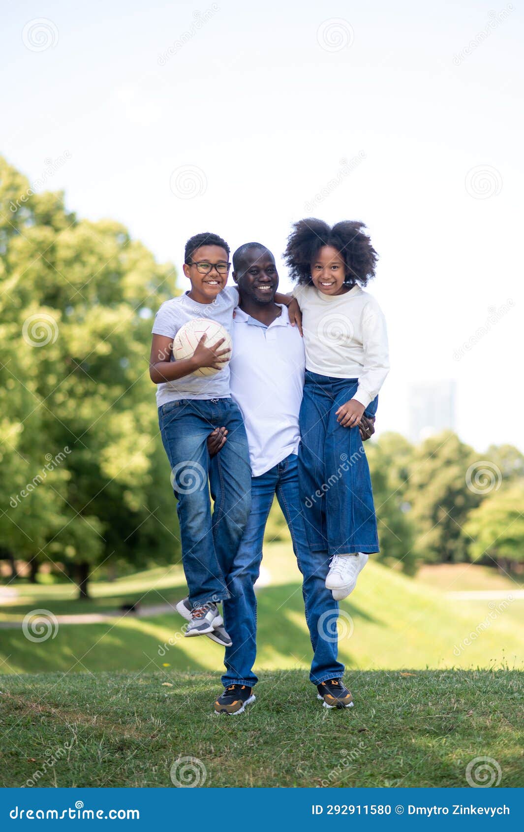 Dad and Two Kids Looking Happy while Spending Time in the Park Together ...