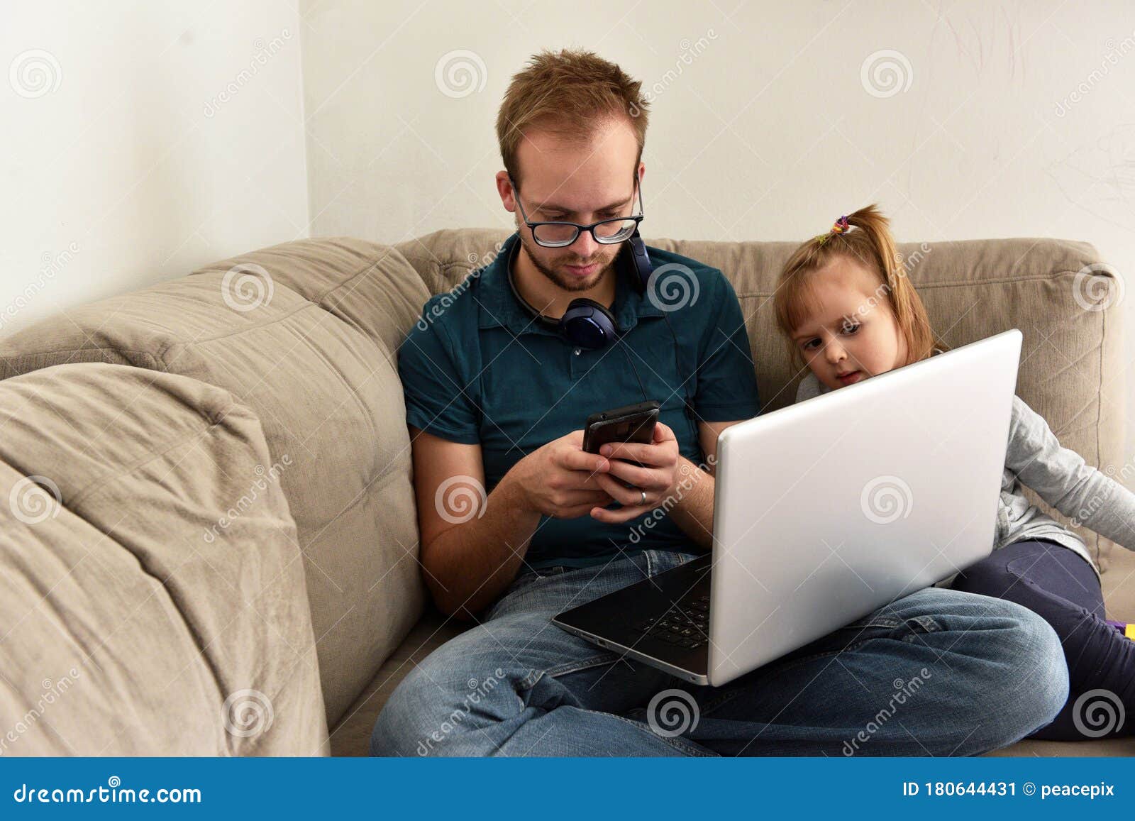 Dad Working from Home on His Computer with His Daughter. Stock Image ...