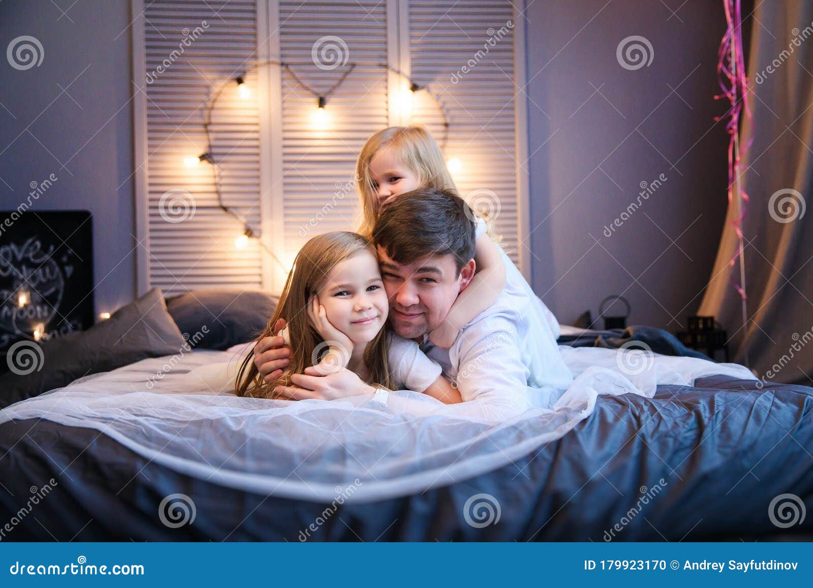 Daddy and Daughter Lying on Bed. Evening at Home Stock Photo - Image of ...