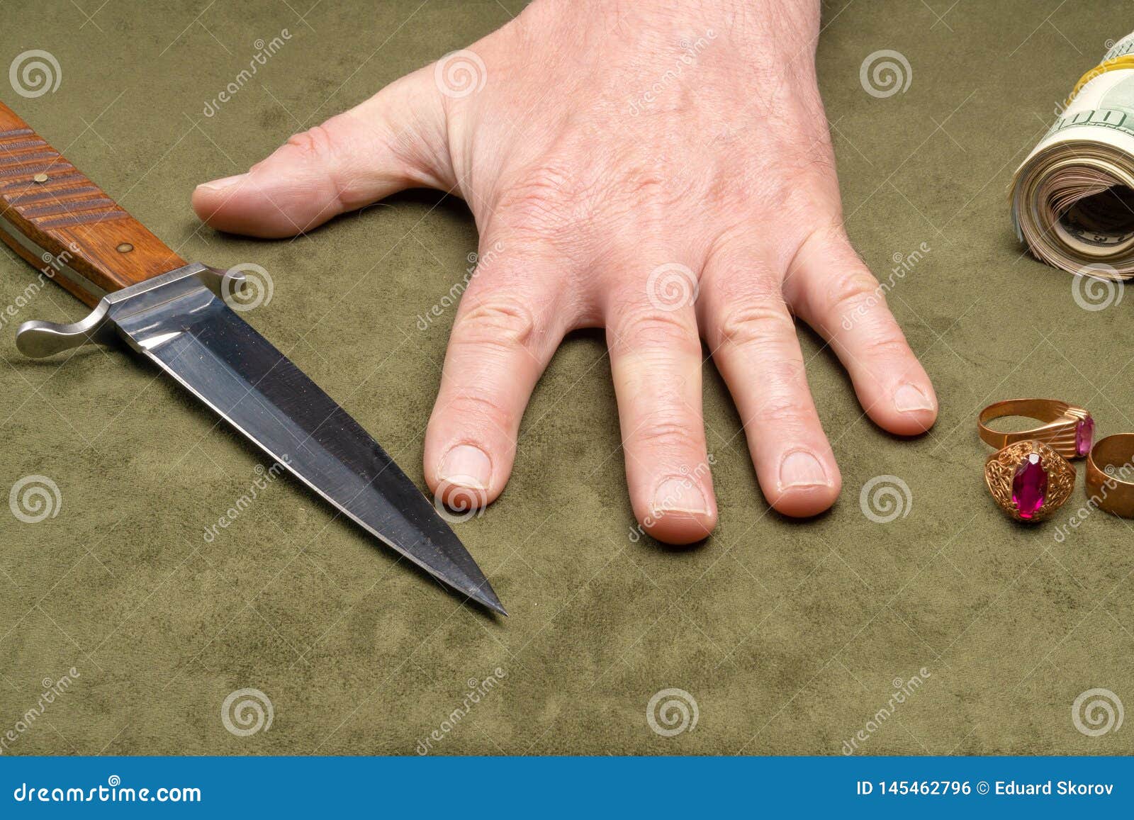 Dagger, Men`s Palm, Dollars and Jewels on a Green Table Stock Photo ...