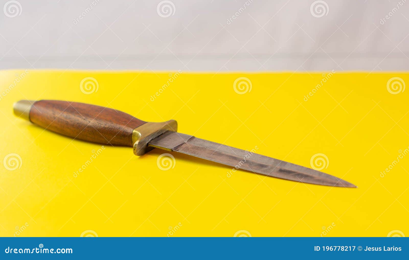 Dagger on the Table in Yellow Background Stock Image - Image of white ...