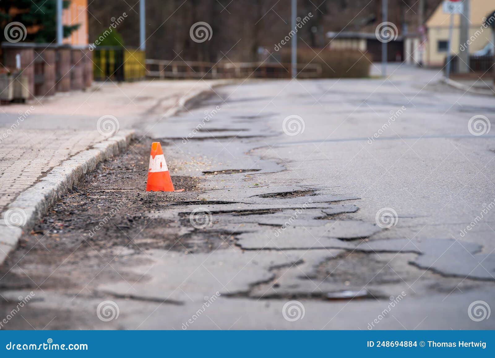 Damaged Asphalt Pavement Road with Potholes and Traffic Cone Stock ...