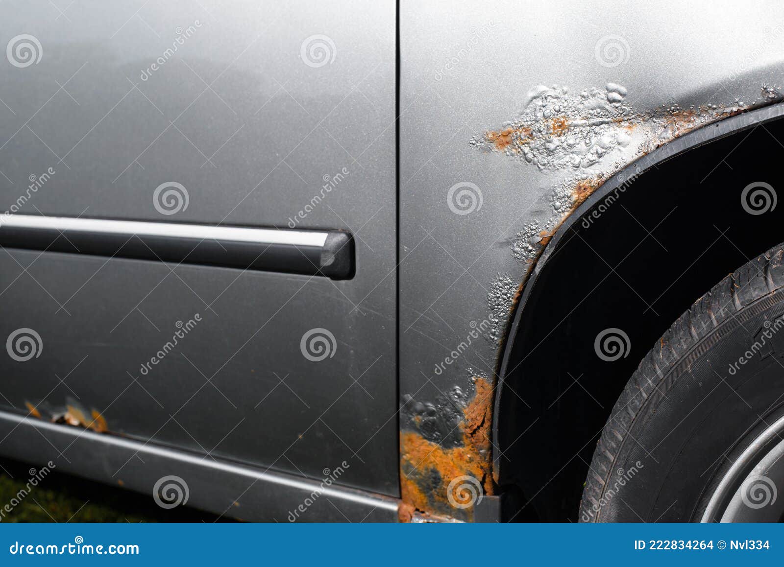 Damaged Car. Rust, Scratches and Cracked Gray Paint on the Front Fender ...