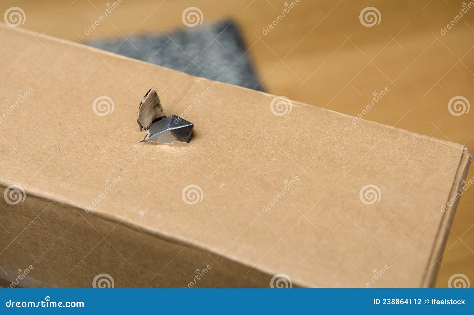 Damaged Parcel Cardboard with a Steel Sharp Object Inside Stock Photo ...