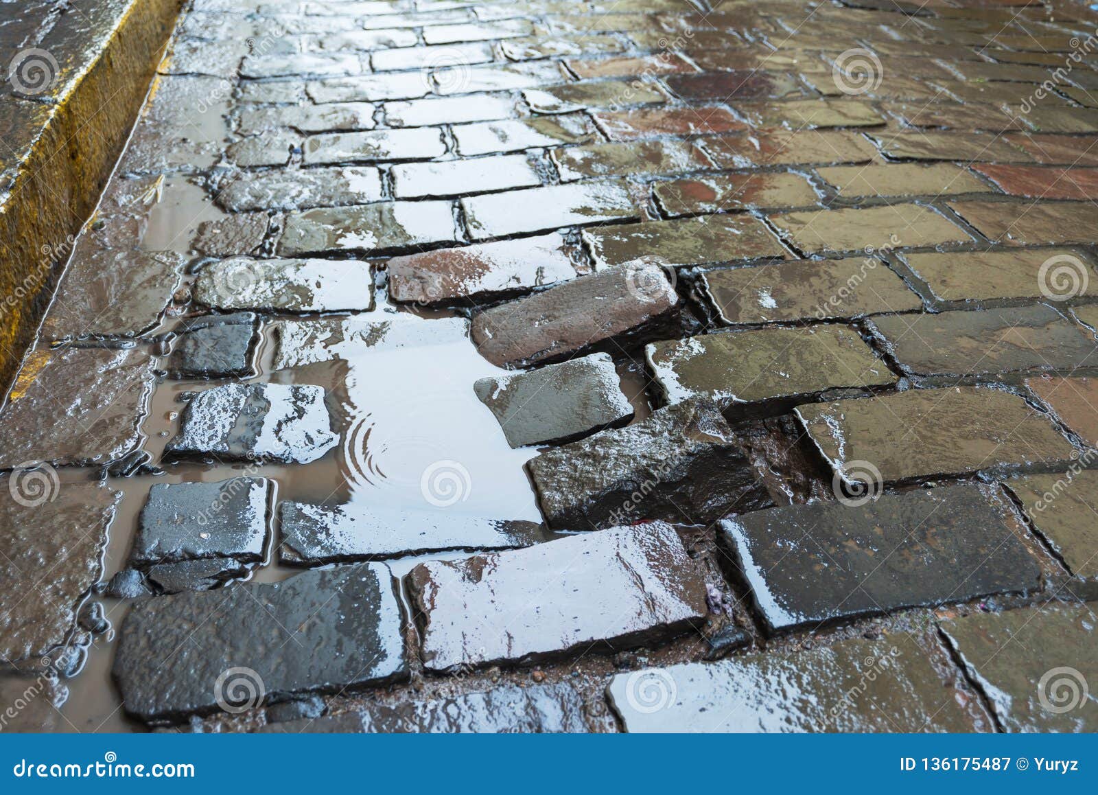 Damaged pavement puddle stock image. Image of cobblestone - 136175487