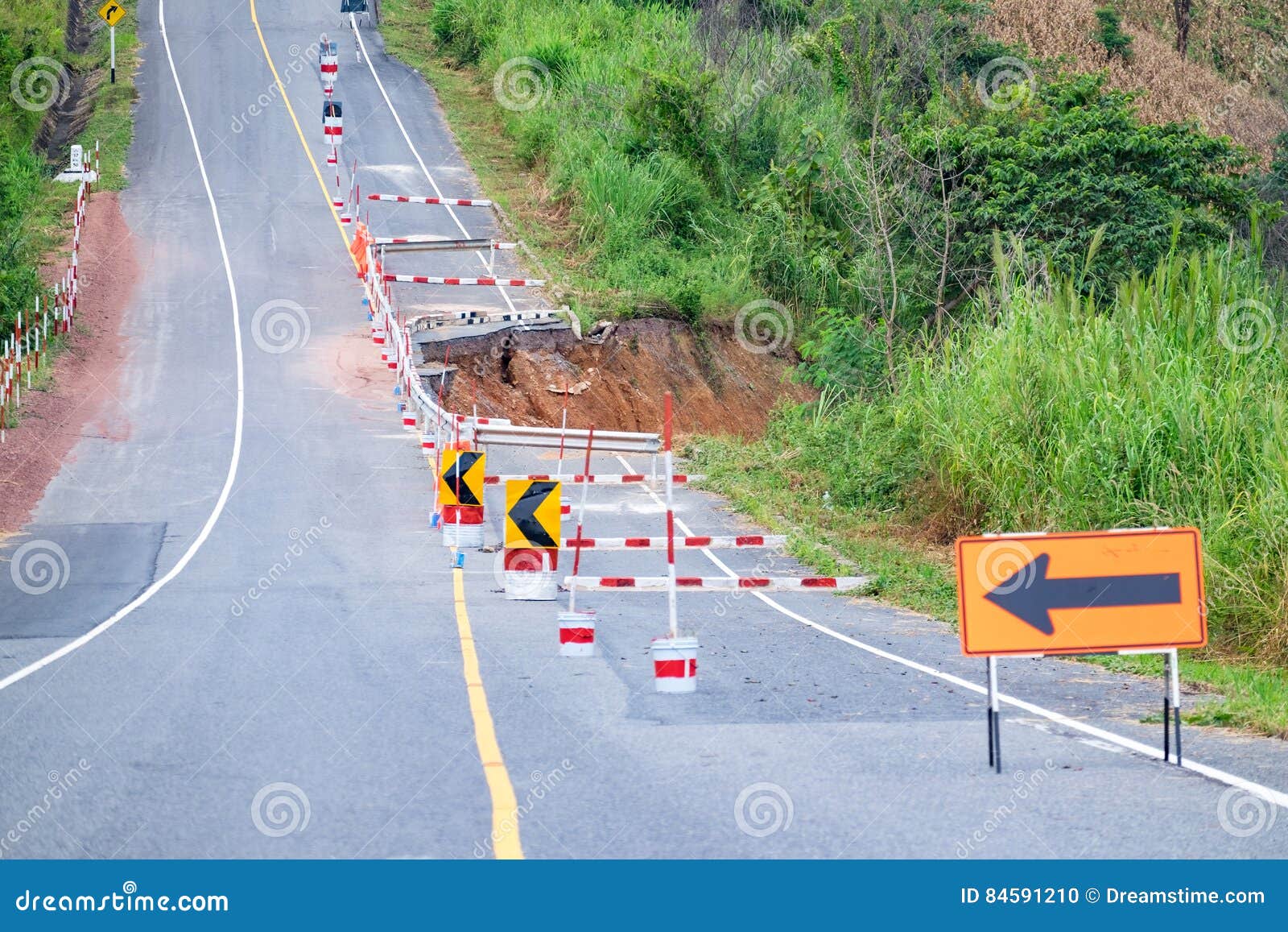 Damaged road with caution stock photo. Image of island - 84591210