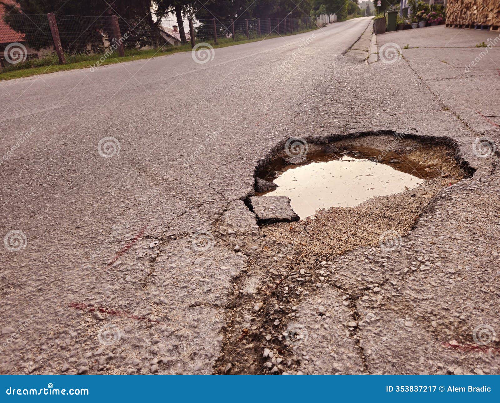 A Photo Of A Pothole-filled Road Covered With Fallen Leaves Royalty ...