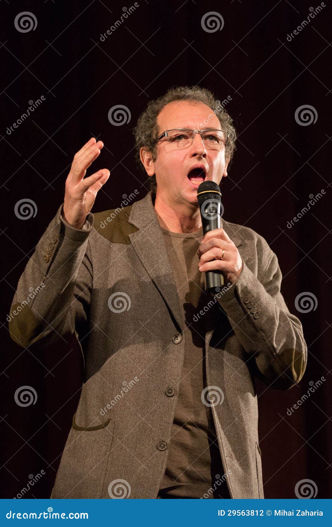 Dan Puric giving a speech editorial photography. Image of microphone ...