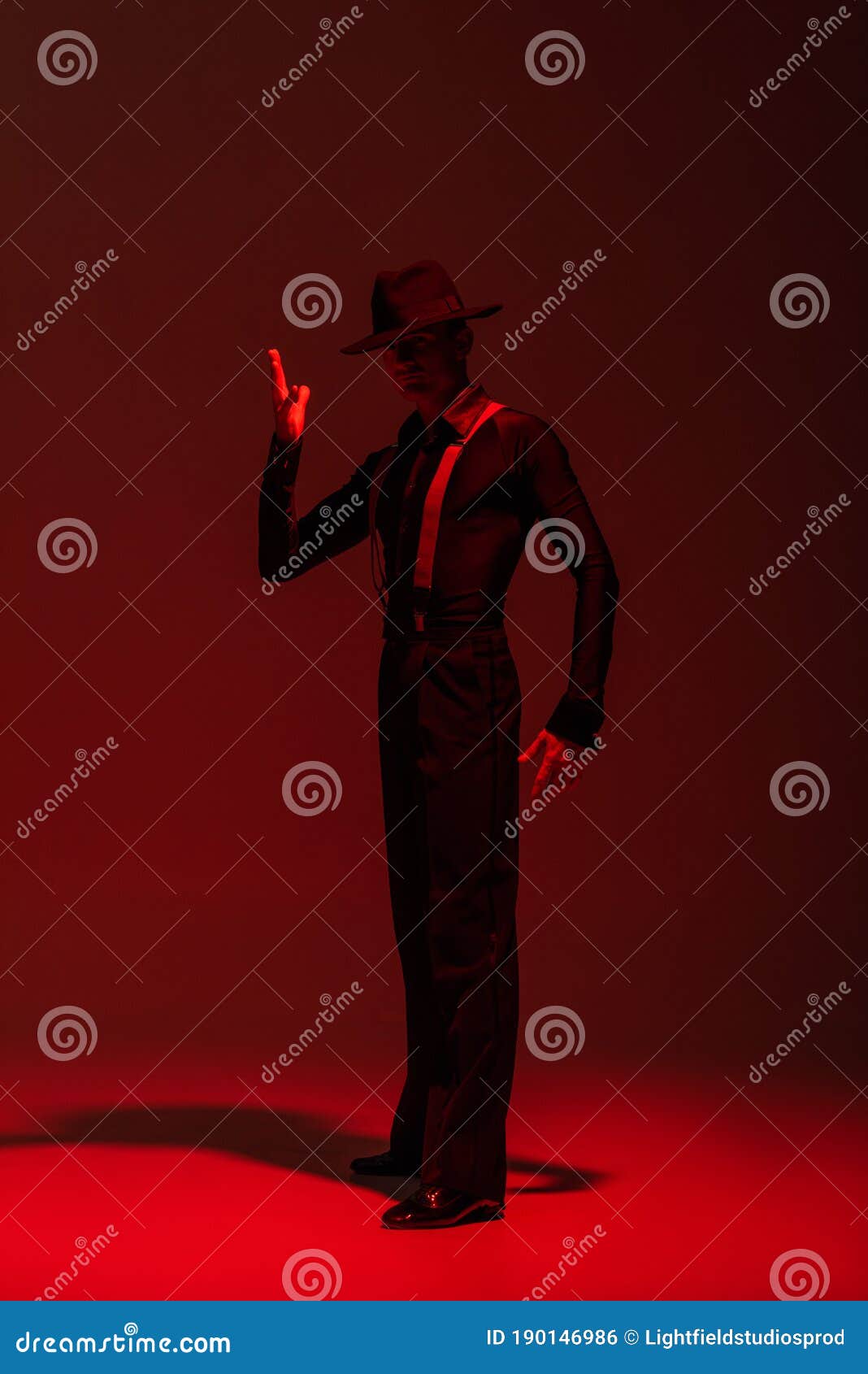 Dancer in Black Hat Performing Tango on Dark Background with Red ...