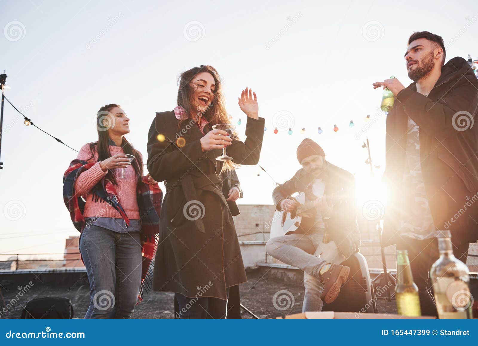 Dancing And Singing Rooftop Party With Some Alcohol Drinking And Guitar Playing Stock Image