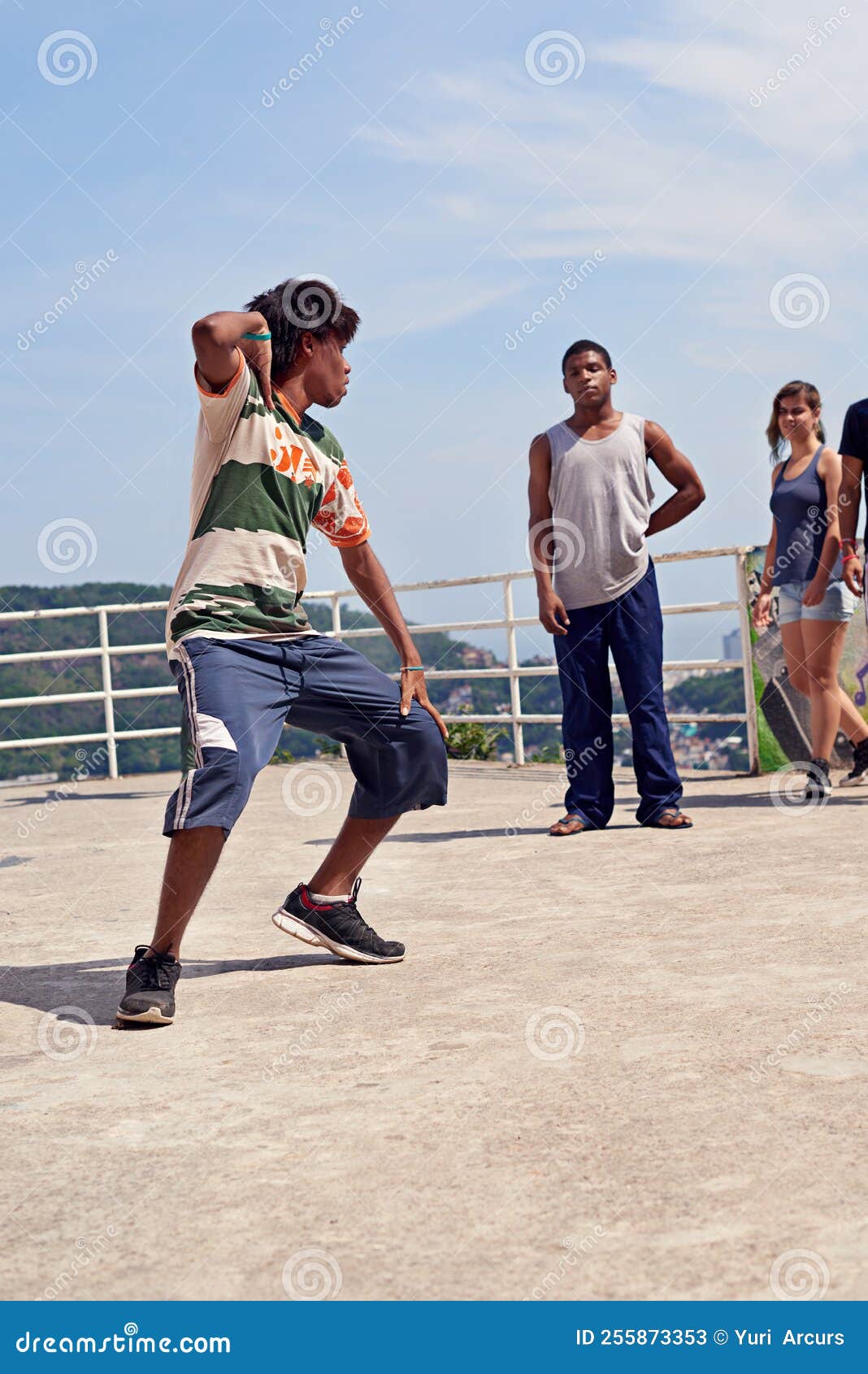 Dancing in the Streets. a Group of Young People Watching a Breakdancer ...