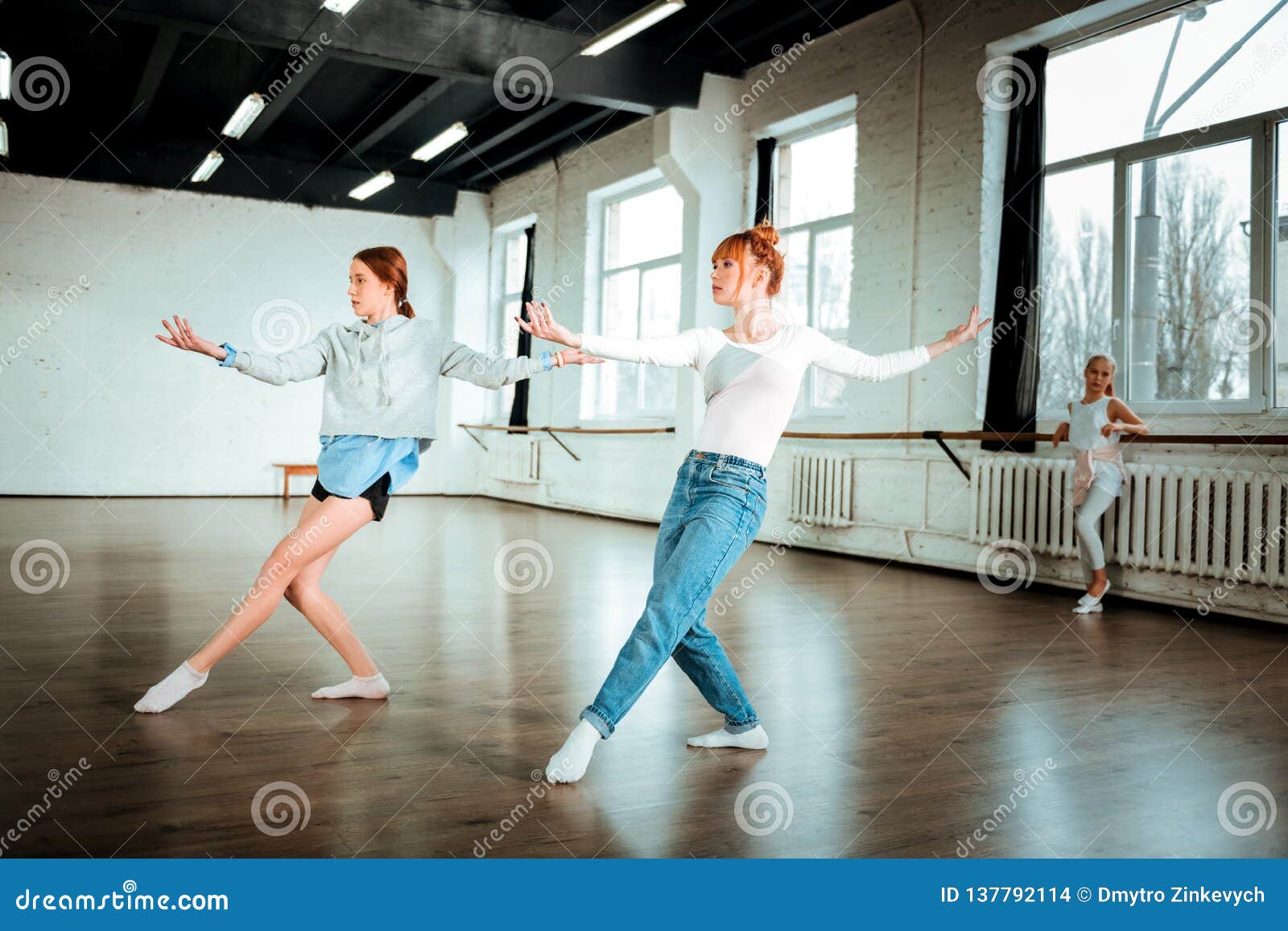 Beautiful Red-haired Professional Dancer in Blue Jeans and Her Student ...