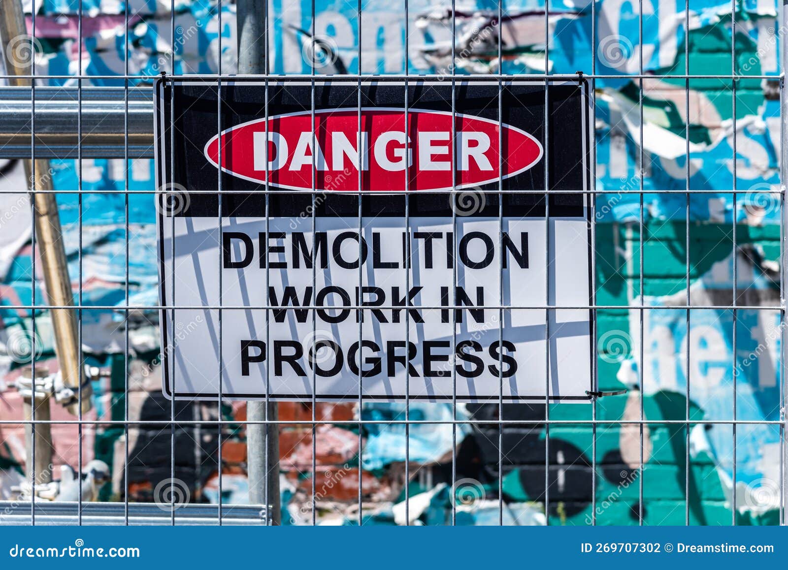 A DANGER DEMOLITION WORK in PROGRESS Sign Mounted on a Wire Fence Stock ...