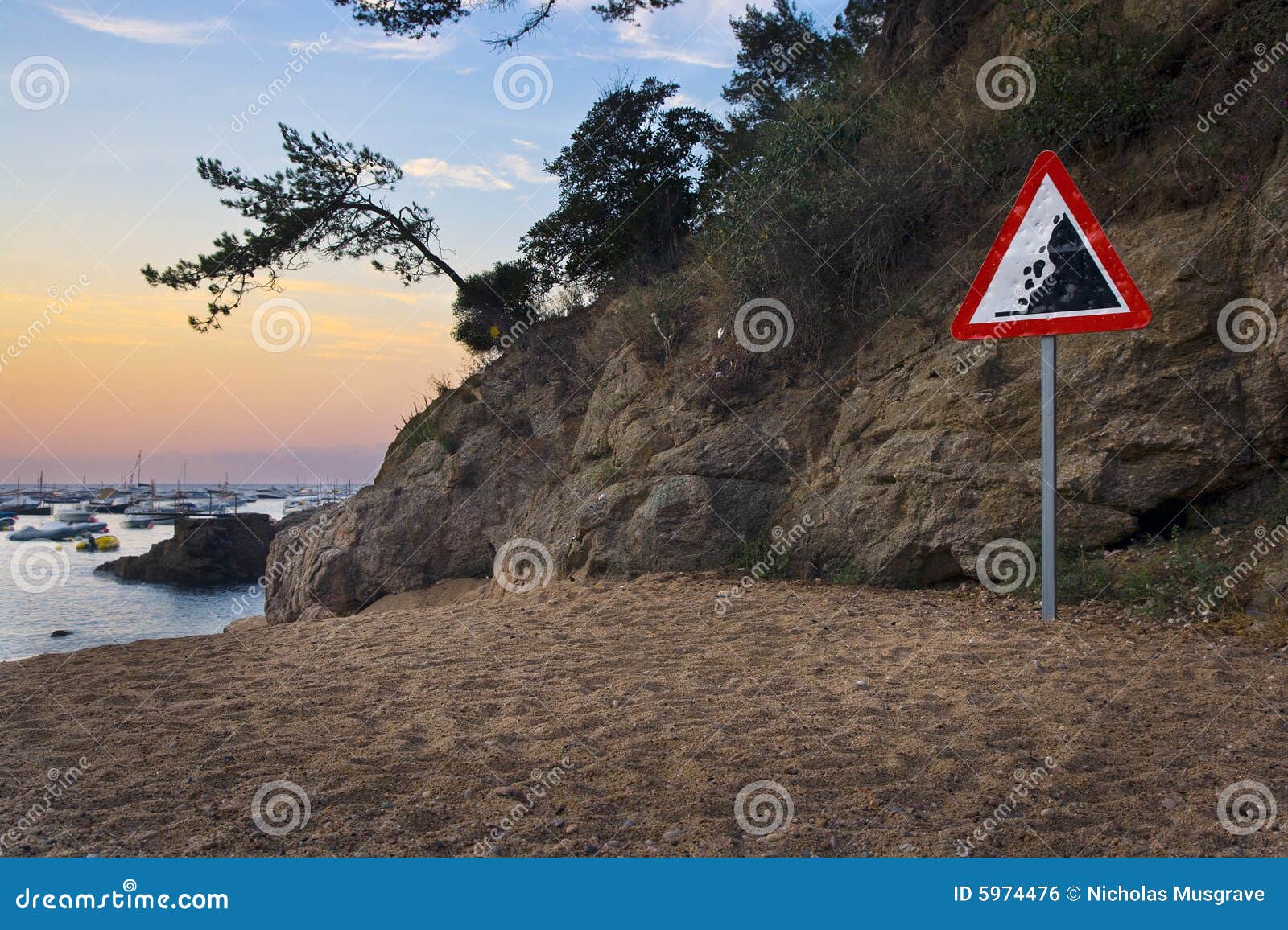 Danger Falling Rocks Sign on Mediterranean Beach Stock Photo - Image of ...