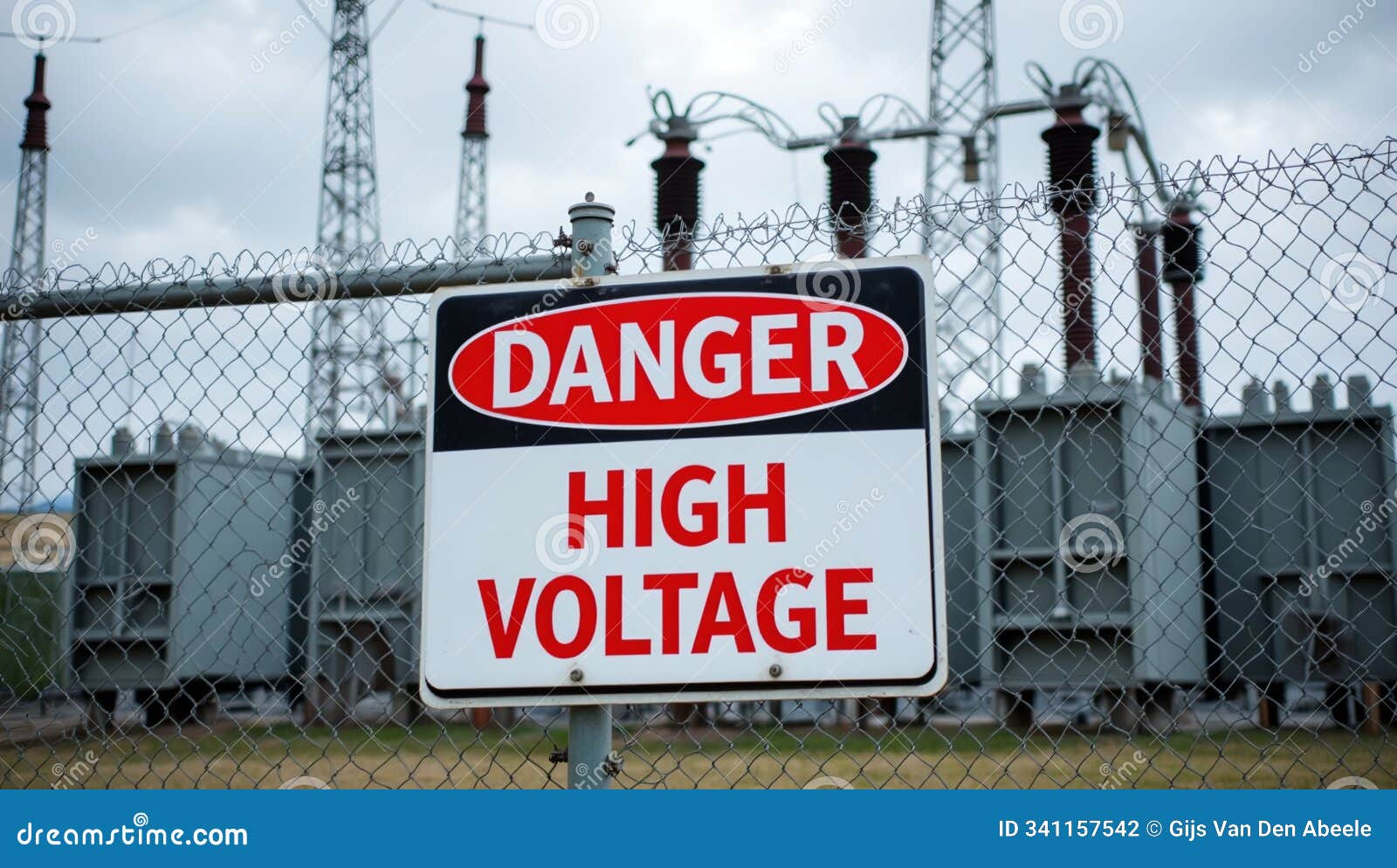 Danger High Voltage Sign on Fence with Blurred Transformers and Power ...