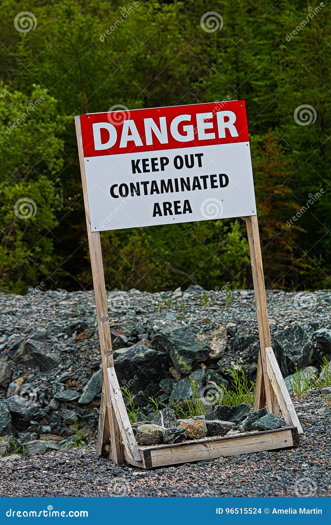 A Danger Keep Out of Contaminated Area Sign on Rocky Ground Stock Photo ...