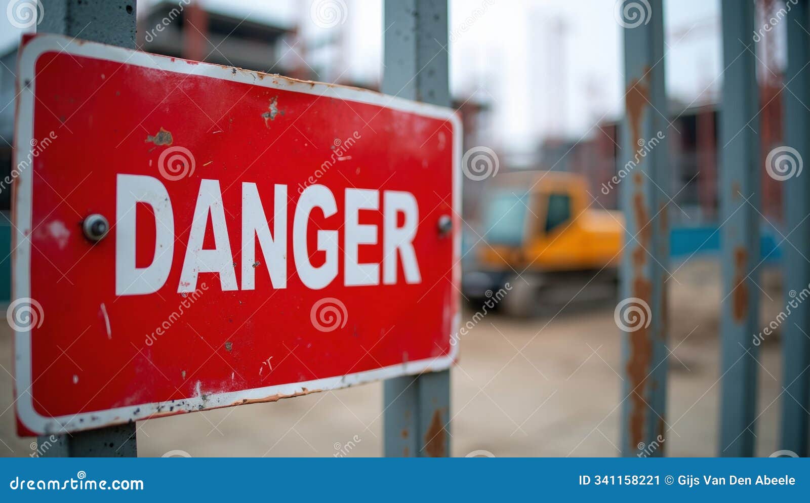 Danger Warning Sign on Metal Gate with Blurry Construction Site Stock ...