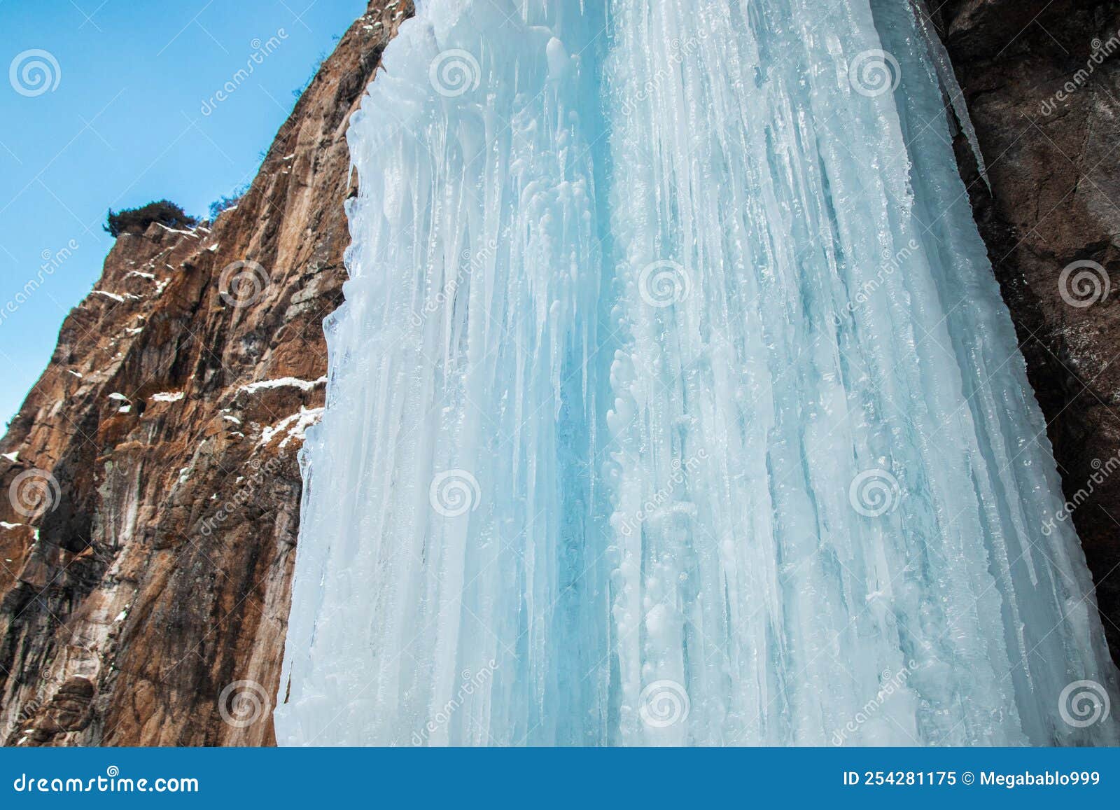 Dangerous Waterfall Frozen in Winter on a Rocky Mountain Stock Image ...