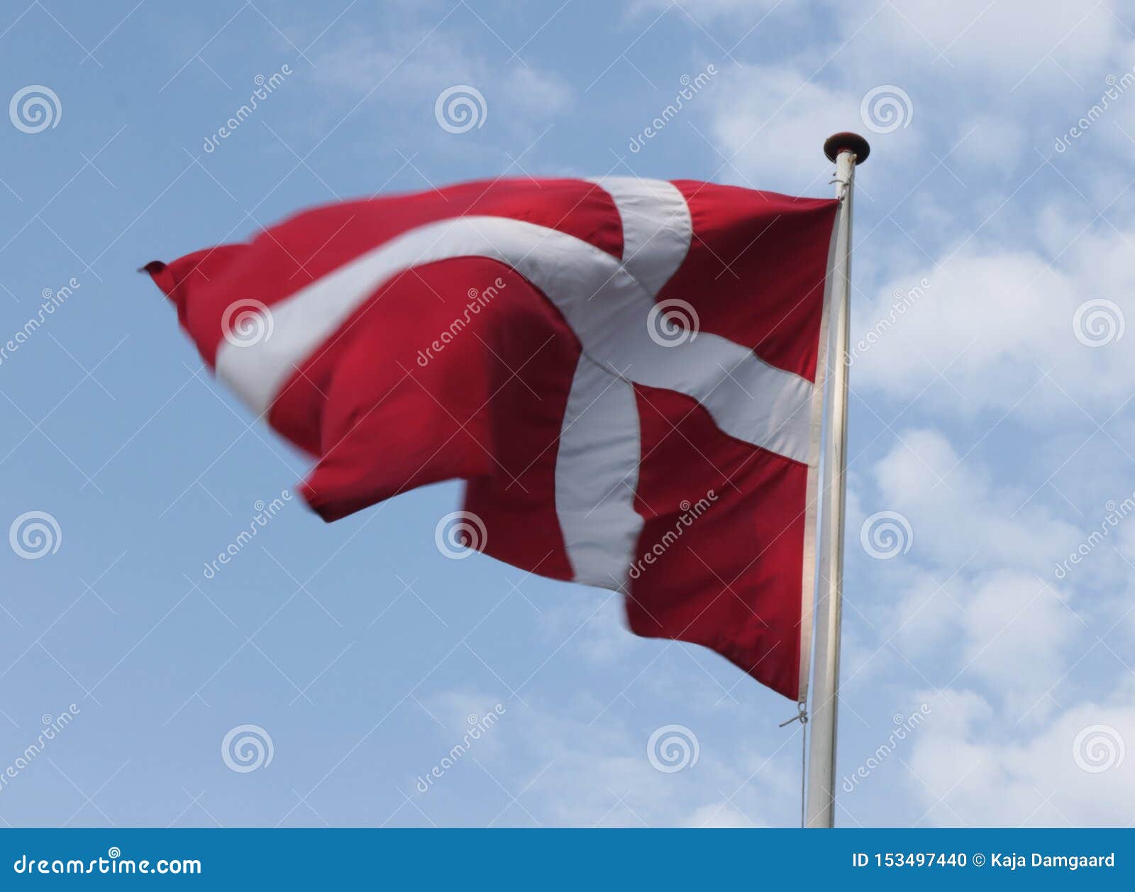 Danish flag at a blue sky stock photo. Image of white - 153497440