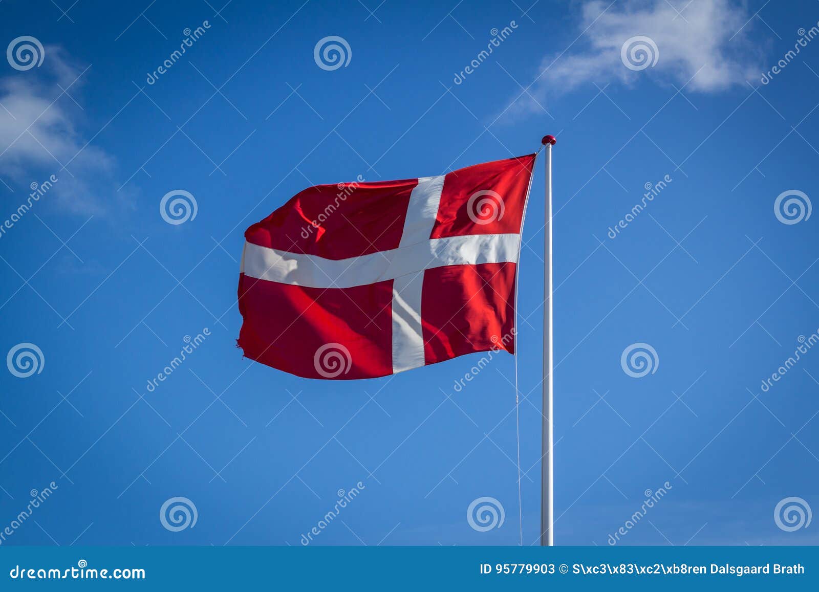 Danish Flag, The Dannebrog, In Front Of A Blue And Cloudy Sky. Stock ...