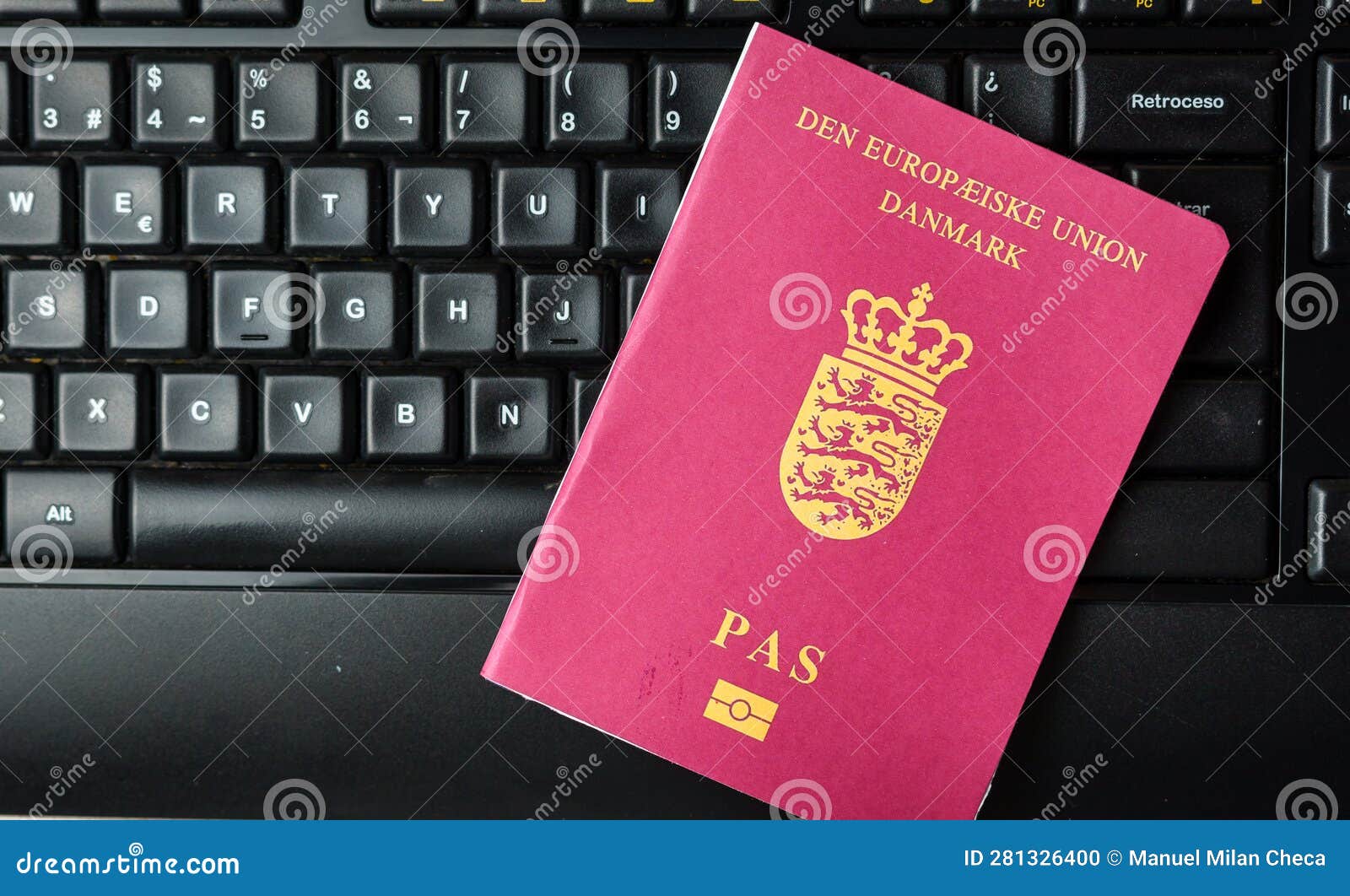 Danish. Passport on a Laptop Keyboard. Online Registration. Immigration ...