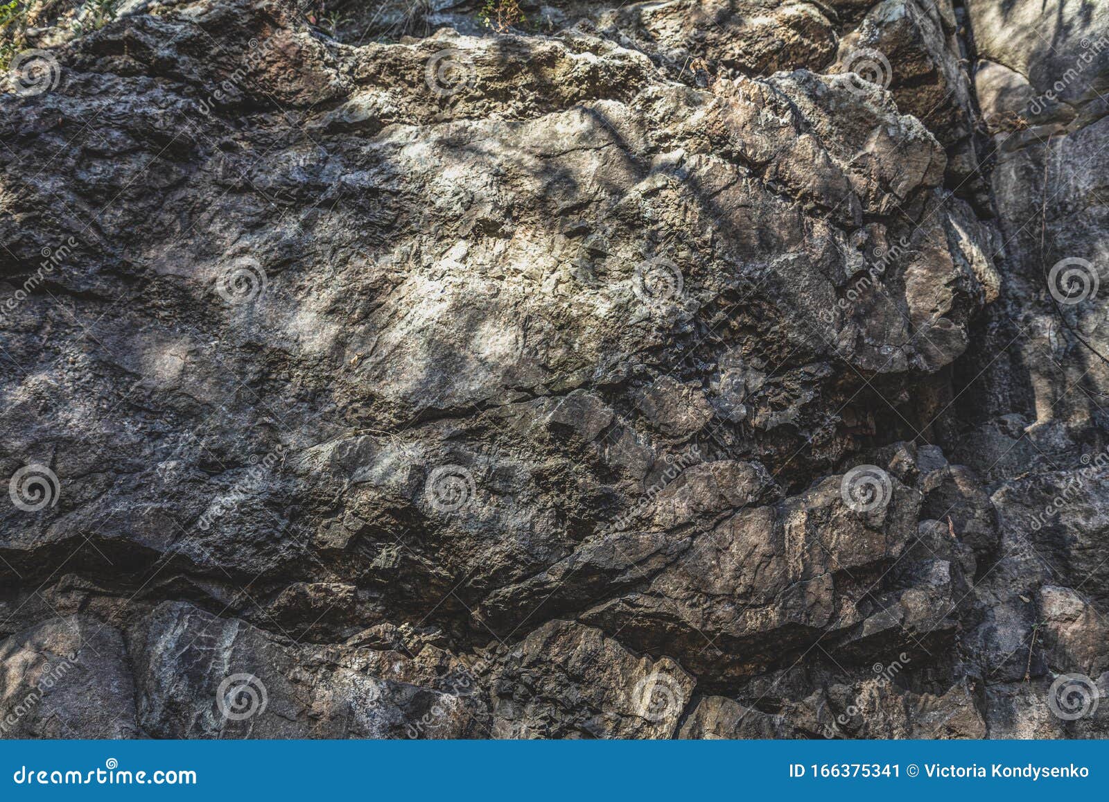 Dark Aged Shabby Cliff Face And Divided By Huge Cracks And Layers ...