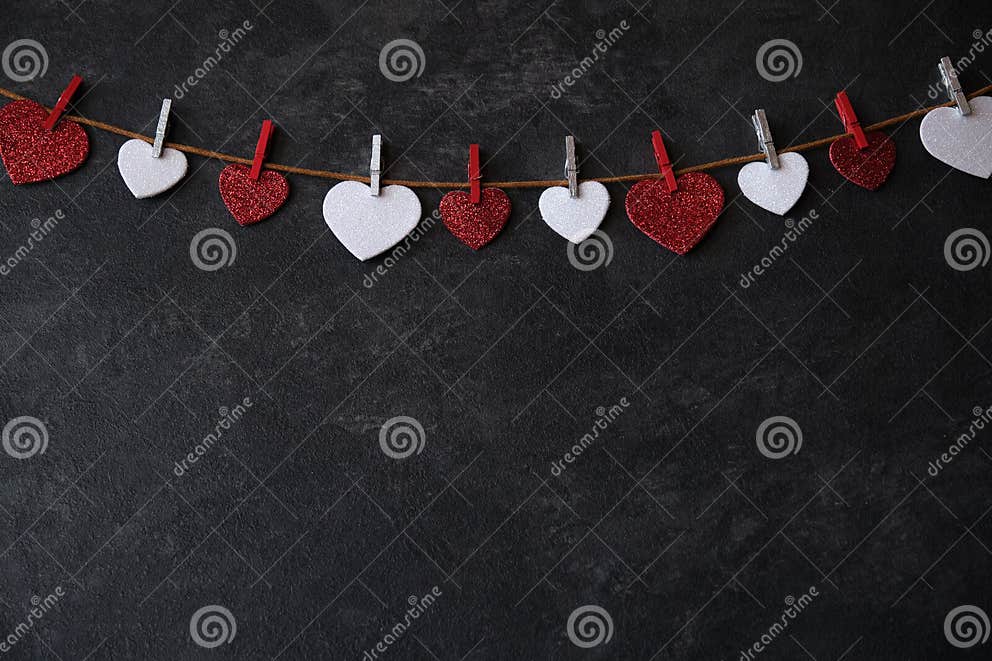 On a Dark Background on a String of Hearts Stock Image - Image of craft ...