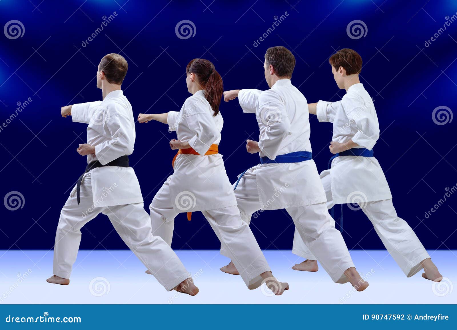 On a Dark Blue Background, Four Athletes Hit with a Hand Stock Photo ...
